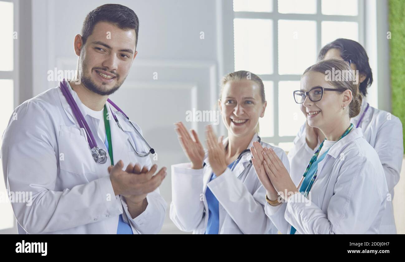 Happy medical team comprising male and female doctors smiling broadly ...