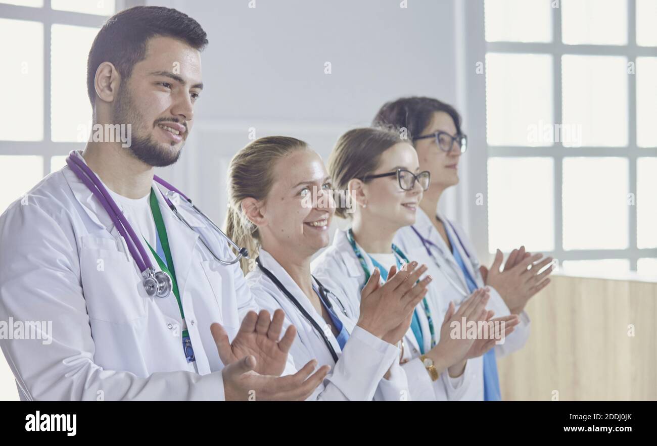 Happy medical team comprising male and female doctors smiling broadly ...