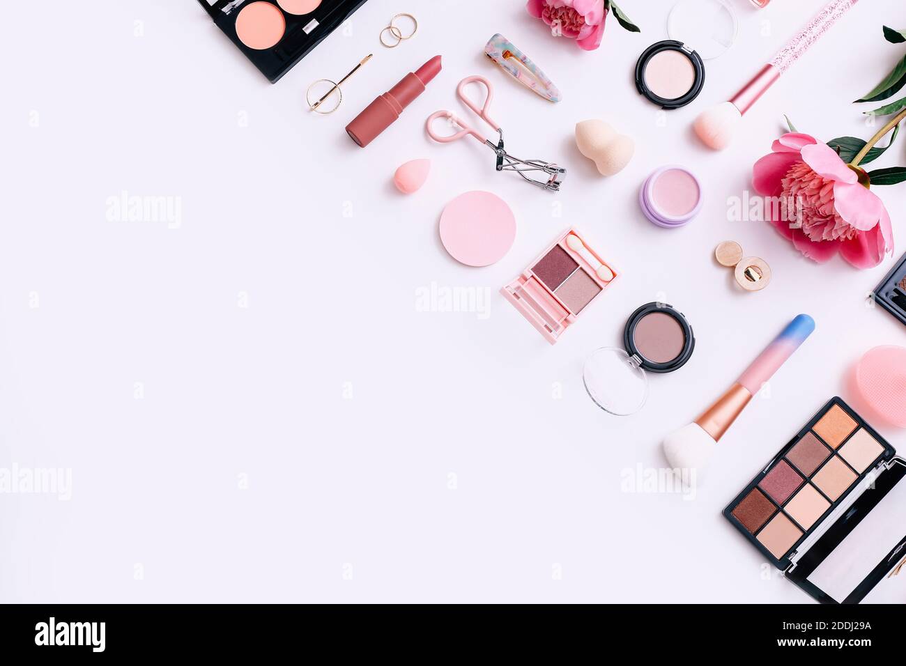 Beauty background with facial cosmetic products and peonies on white ...