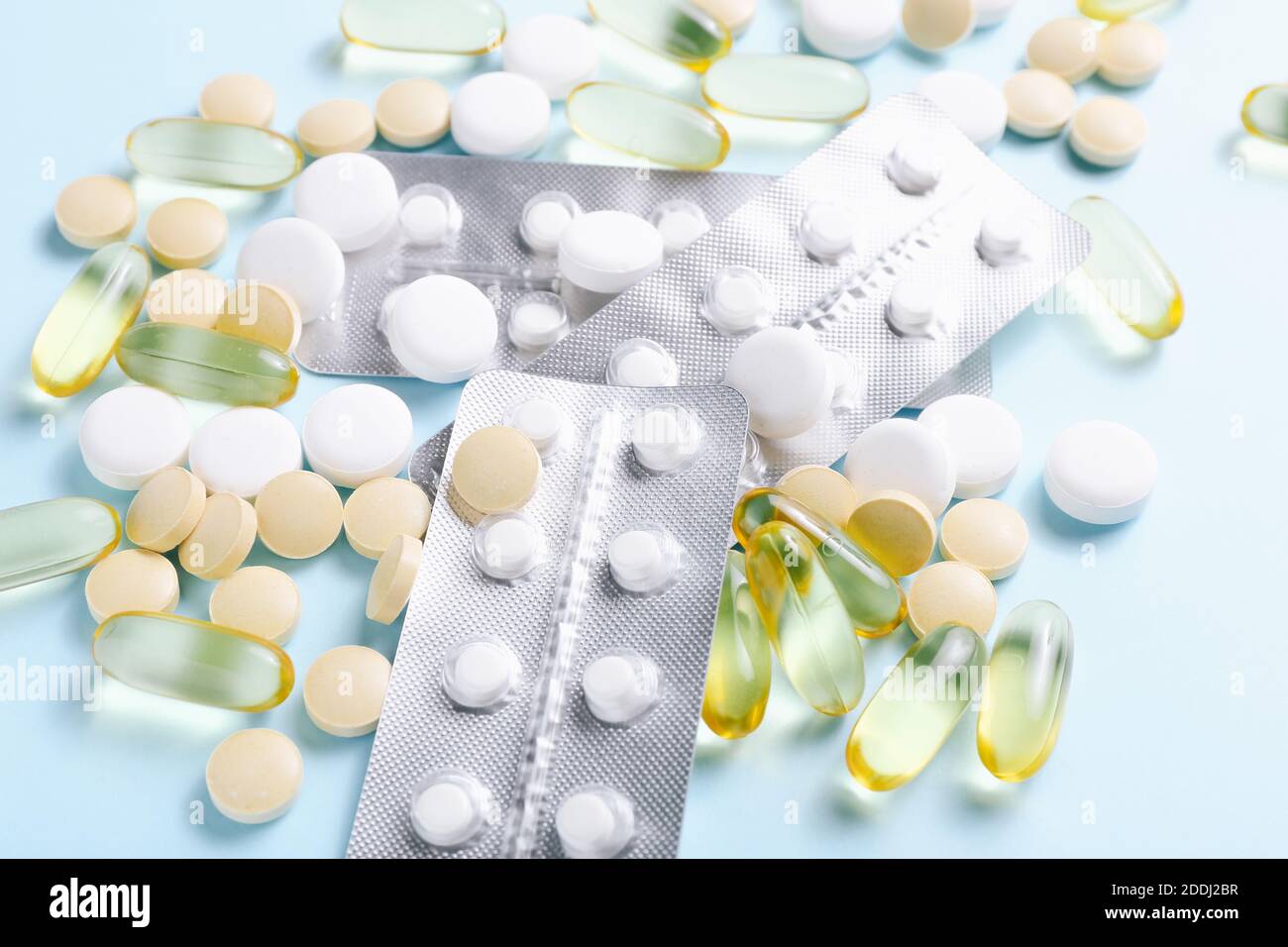 Different pharmaceutical medicine vitamins, pills, drugs on blue ...
