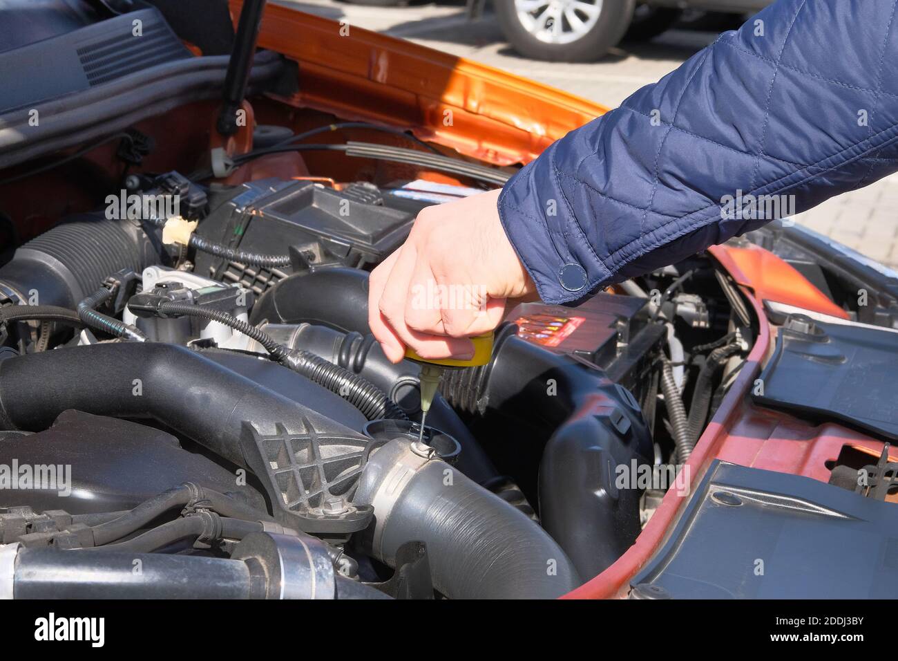 Automobile maintenance concept. Driver checking oil level in car engine ...