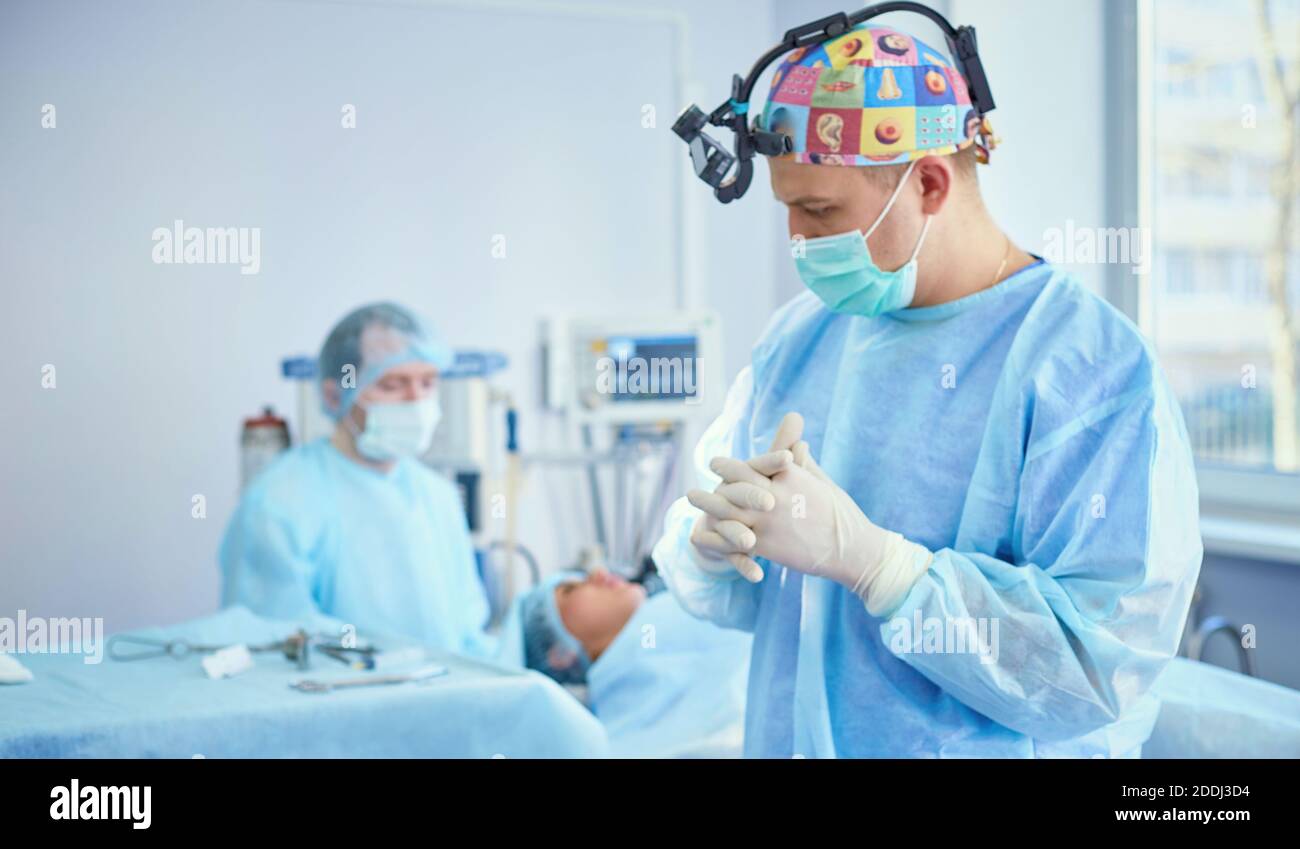 Several doctors surrounding patient on operation table during their ...