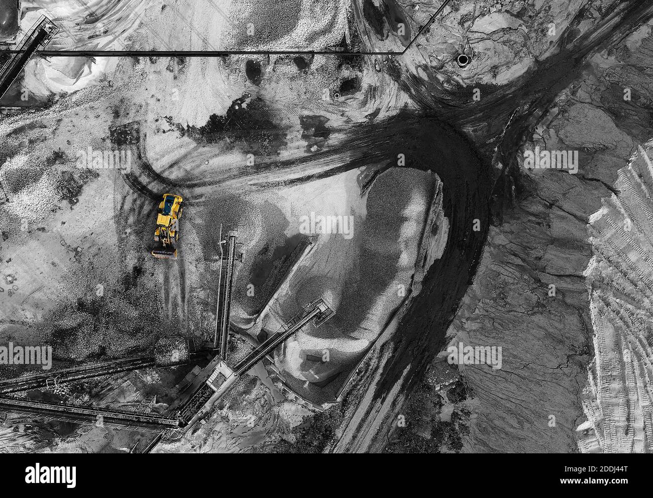 Heavy machines, including yellow trucks, in the working environment in ...