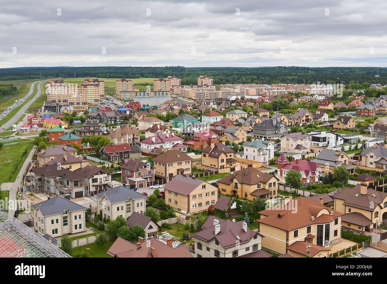 private houses in a suburban neighborhood at the edge of the forest ...