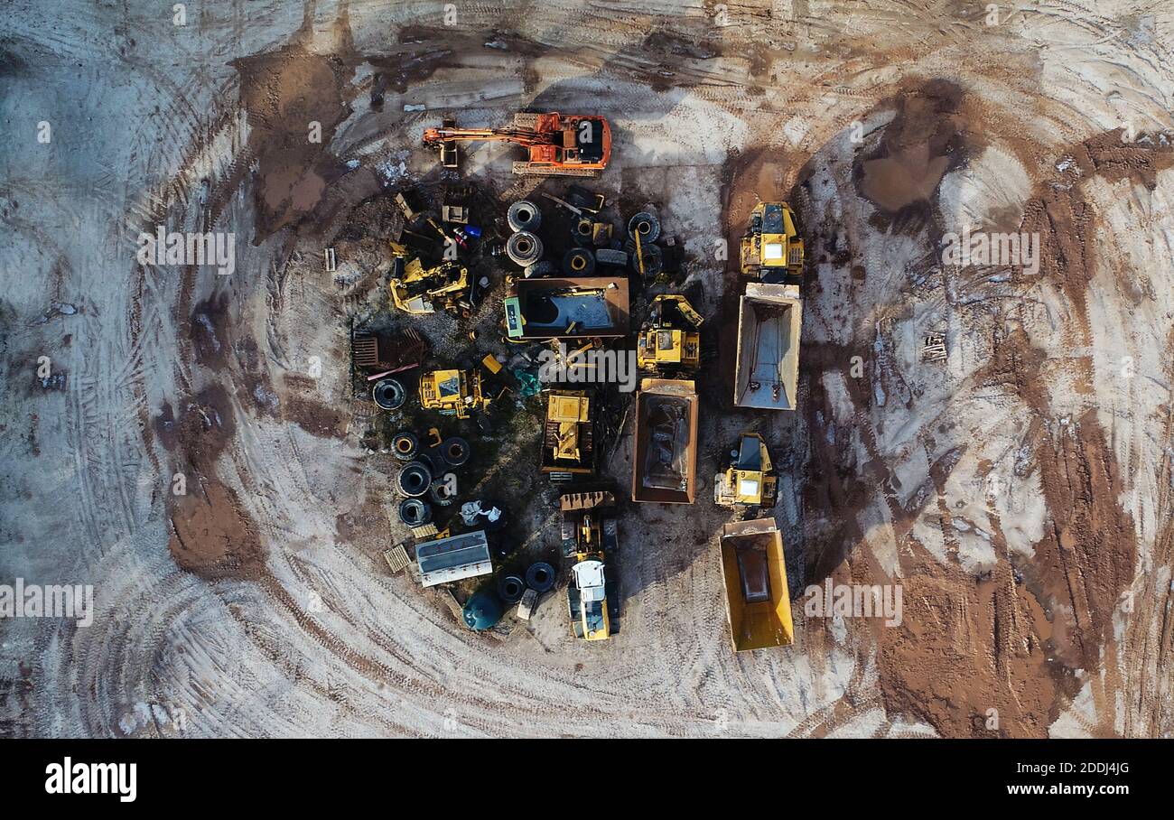 Heavy machines, including yellow trucks, in the working environment in ...