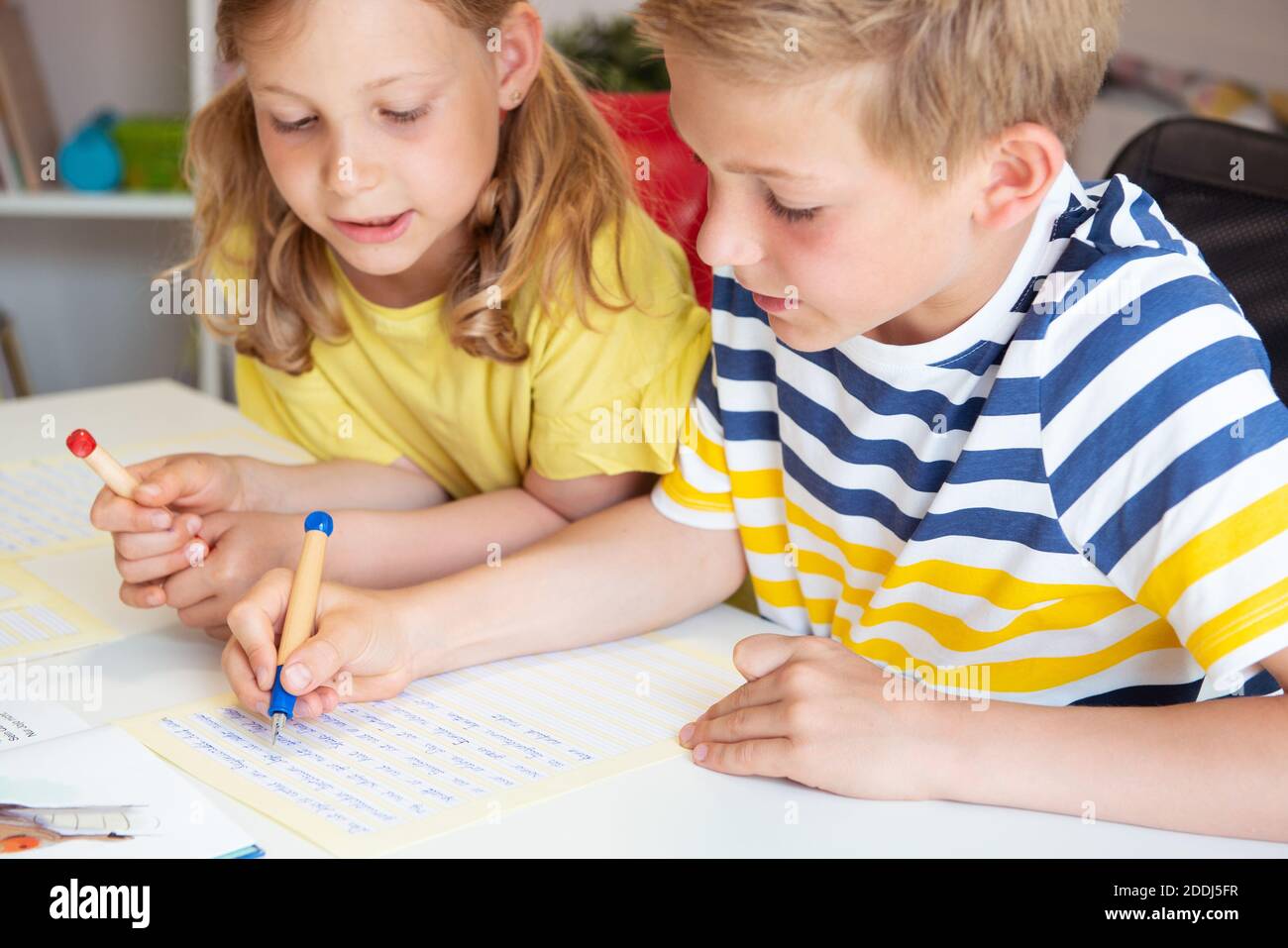 Cute schoolchildren are came back to school and learning and writing at ...