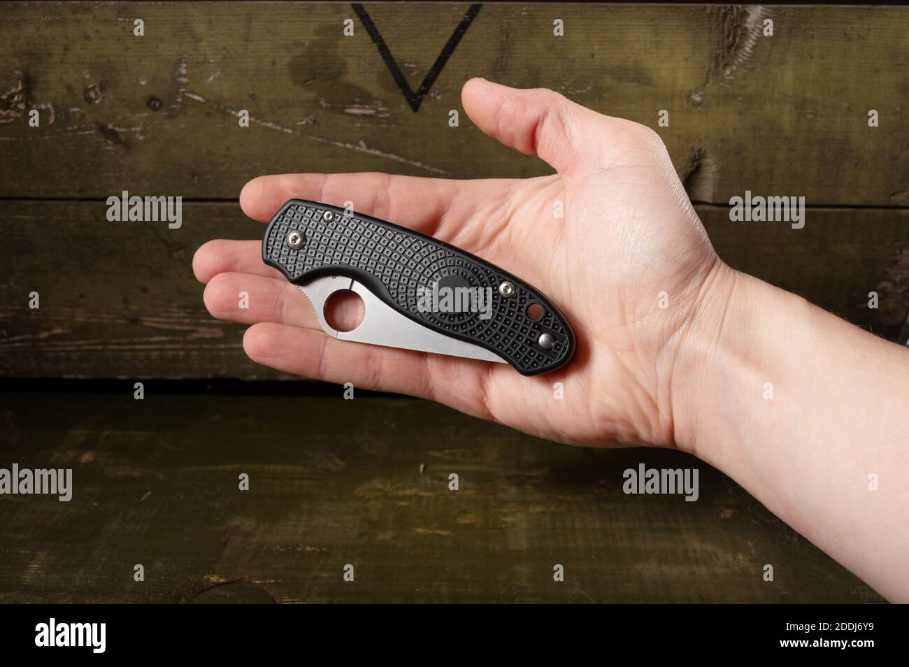 Folded knife in the palm of your hand. Small everyday knife in the palm ...