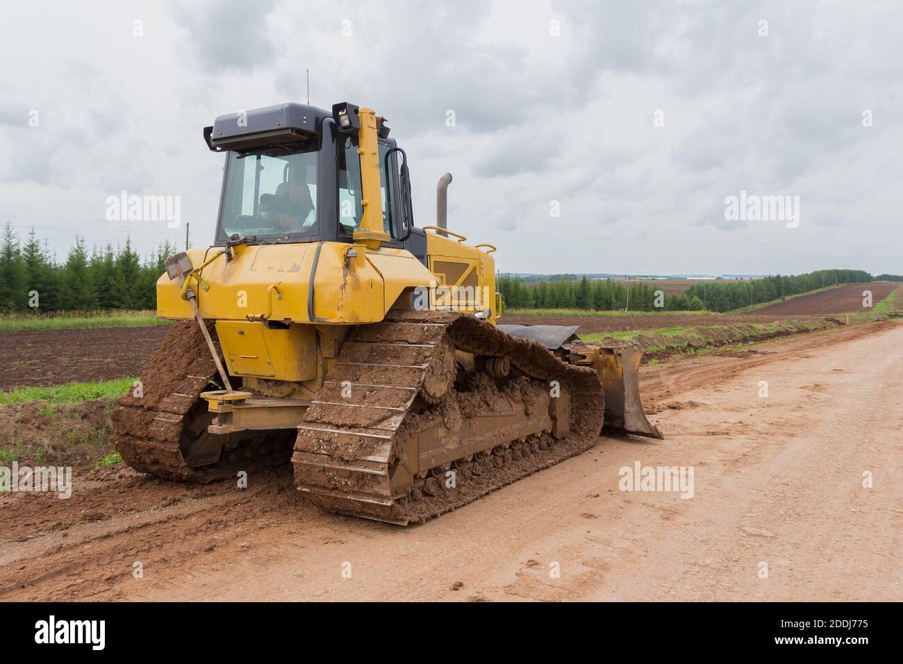 Bulldozer during road construction. Construction machinery. Earth ...