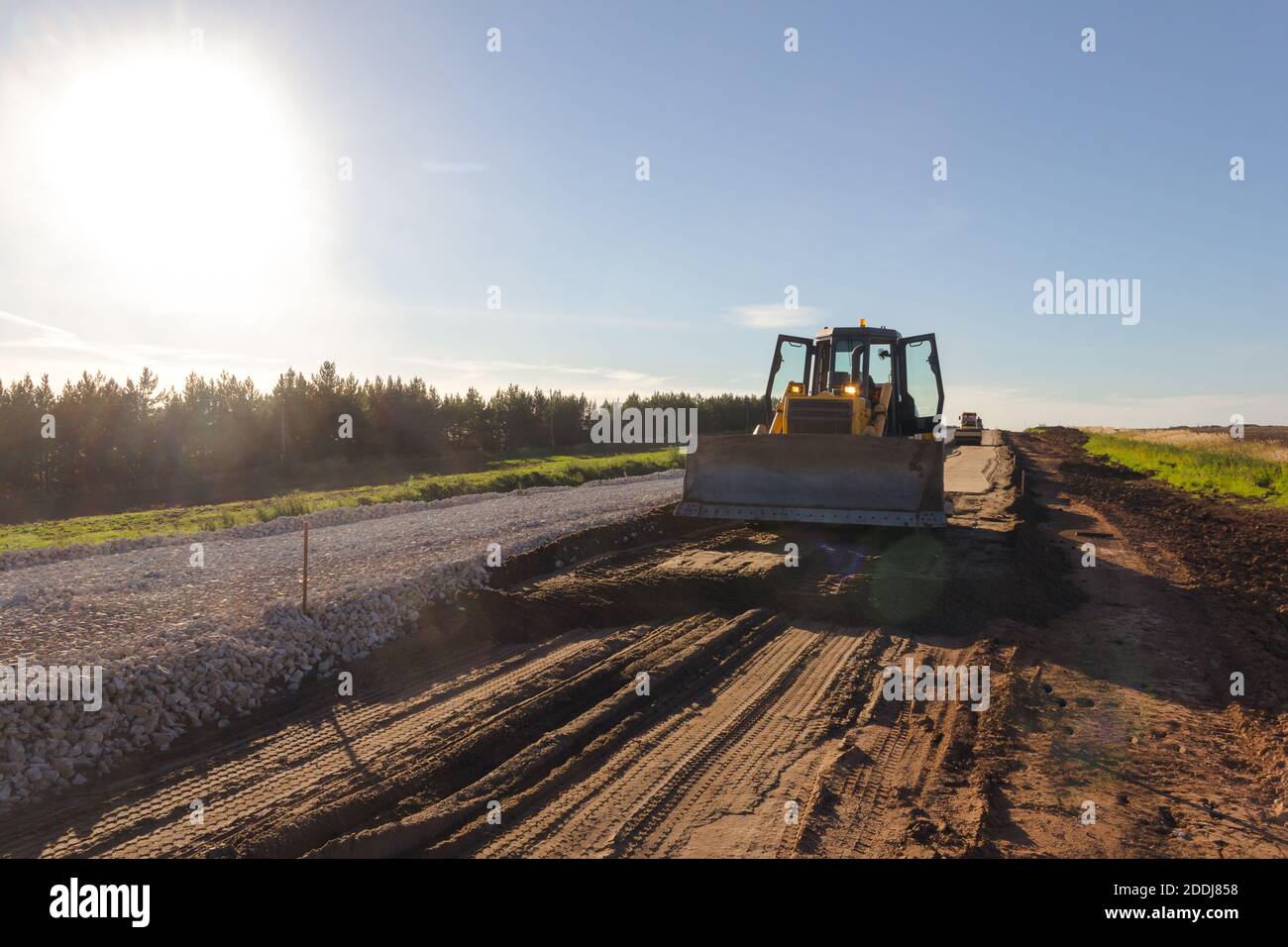 Bulldozer during road construction. Construction machinery. Earth ...