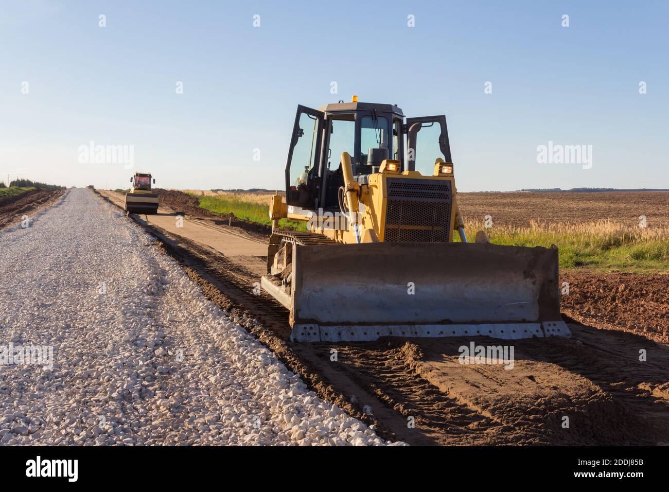 Bulldozer during road construction. Construction machinery. Earth ...