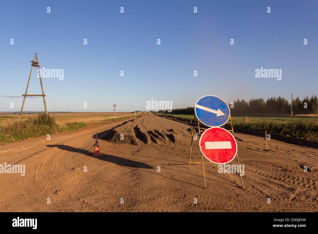 No entry road sign and directional sign on the background of a road ...