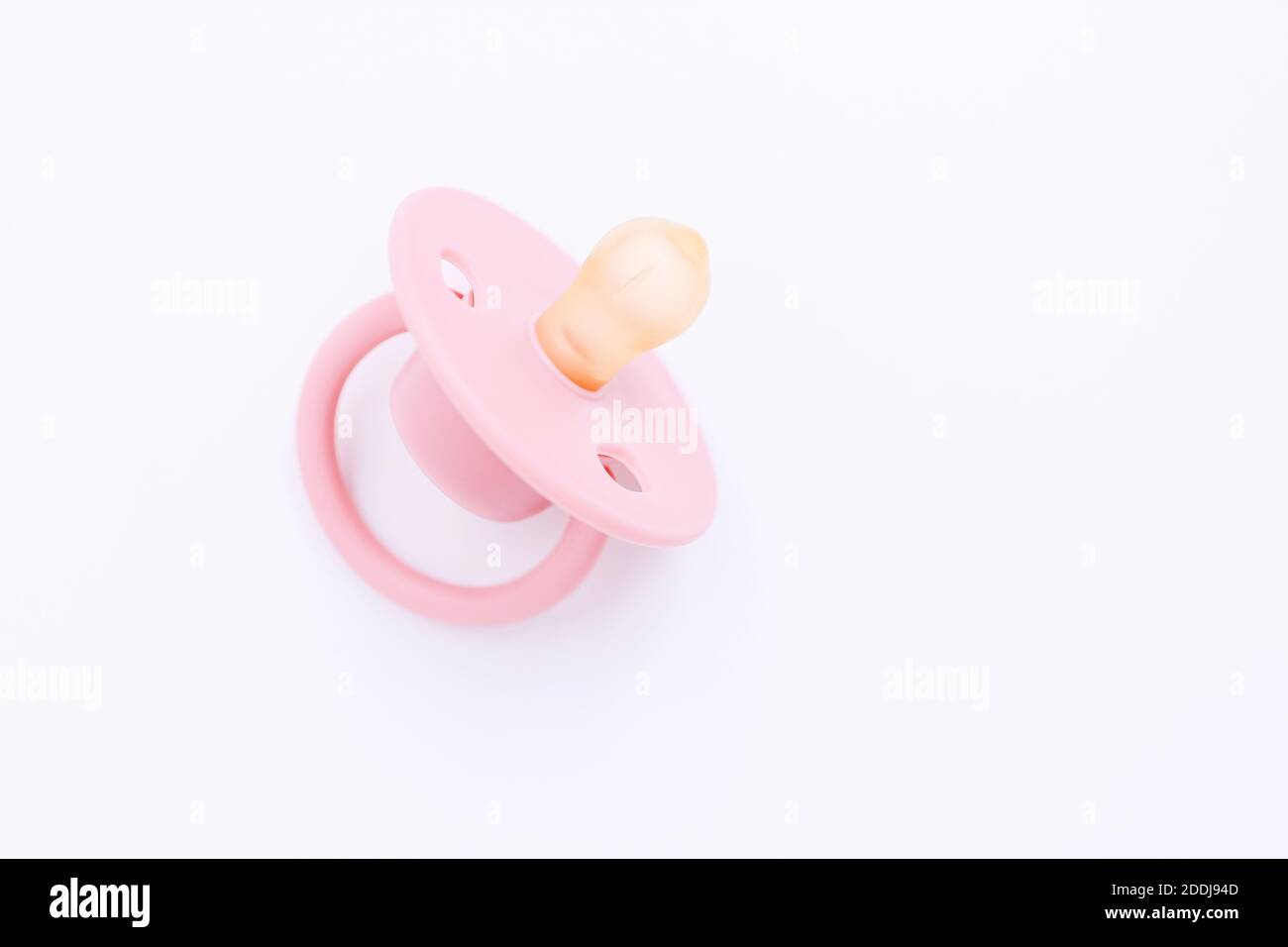 Pink baby's pacifier isolated on white background Stock Photo - Alamy