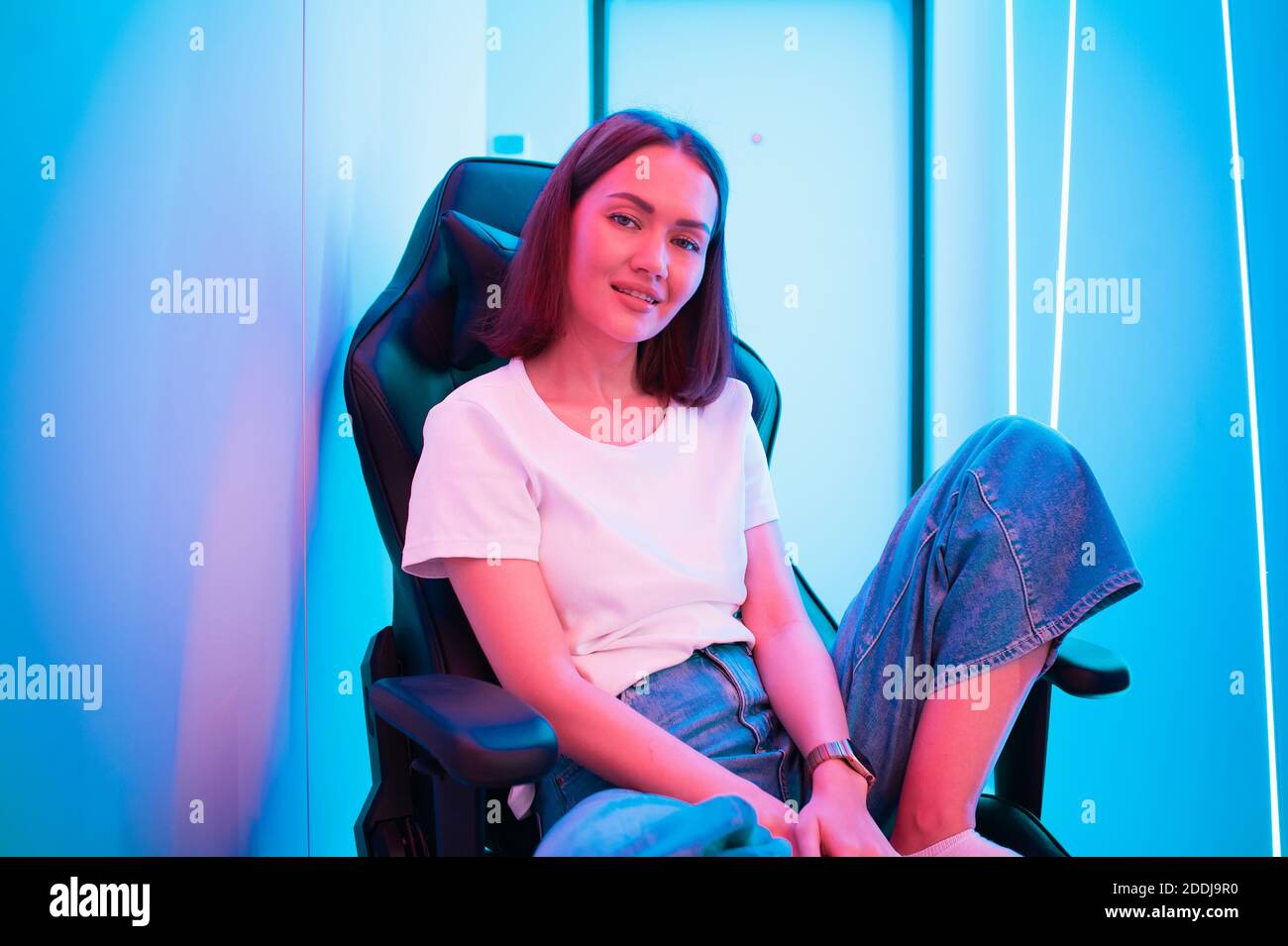 Streamer girl relaxing sitting on a gaming chair after live stream ...
