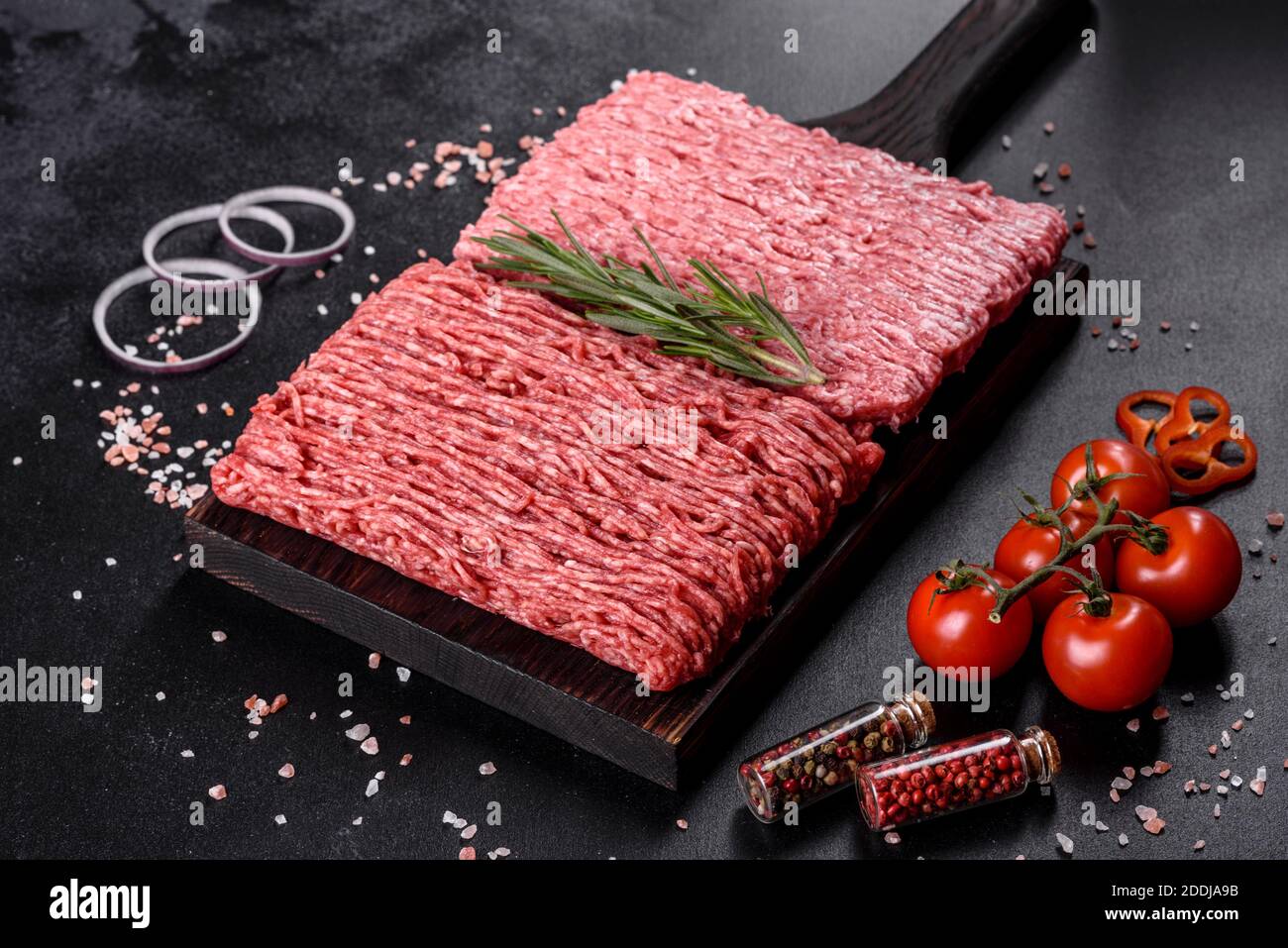 Fresh raw beef mince on a dark background. Preparation for cooking of ...