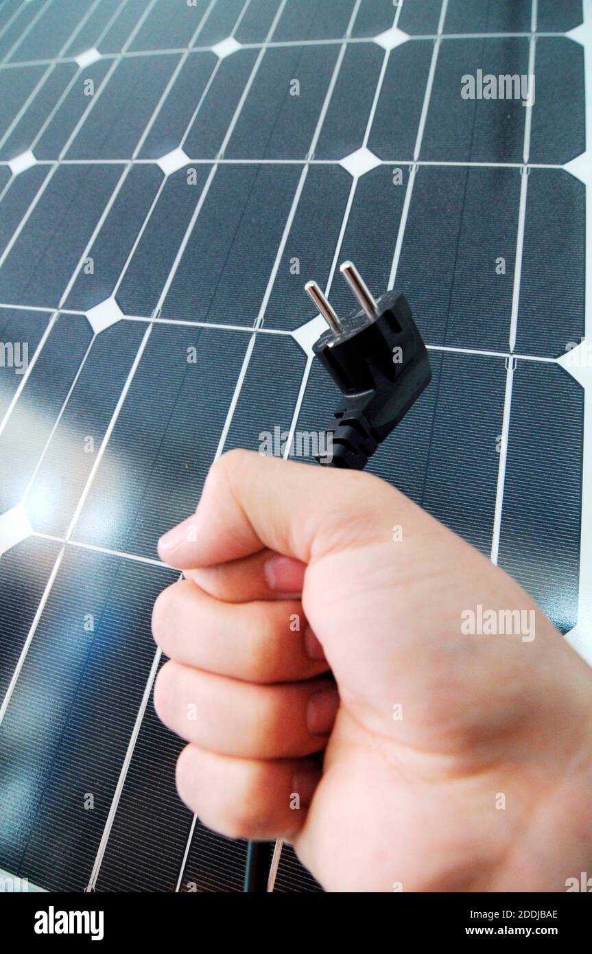 a power plug and solar panel, sustainable and ecological energy ...