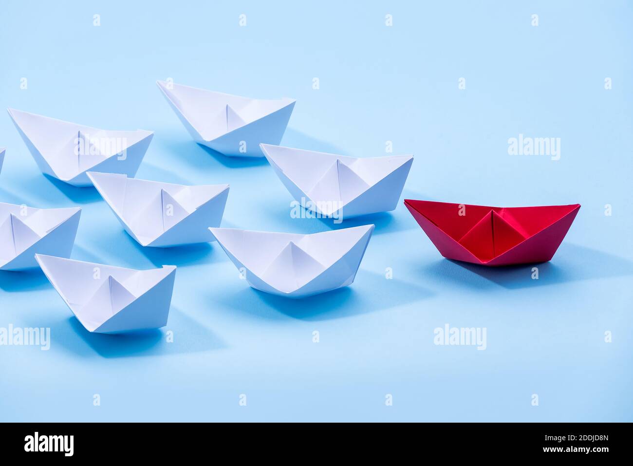 Red and white paper boats. Concept of leadership boats for teamwork ...