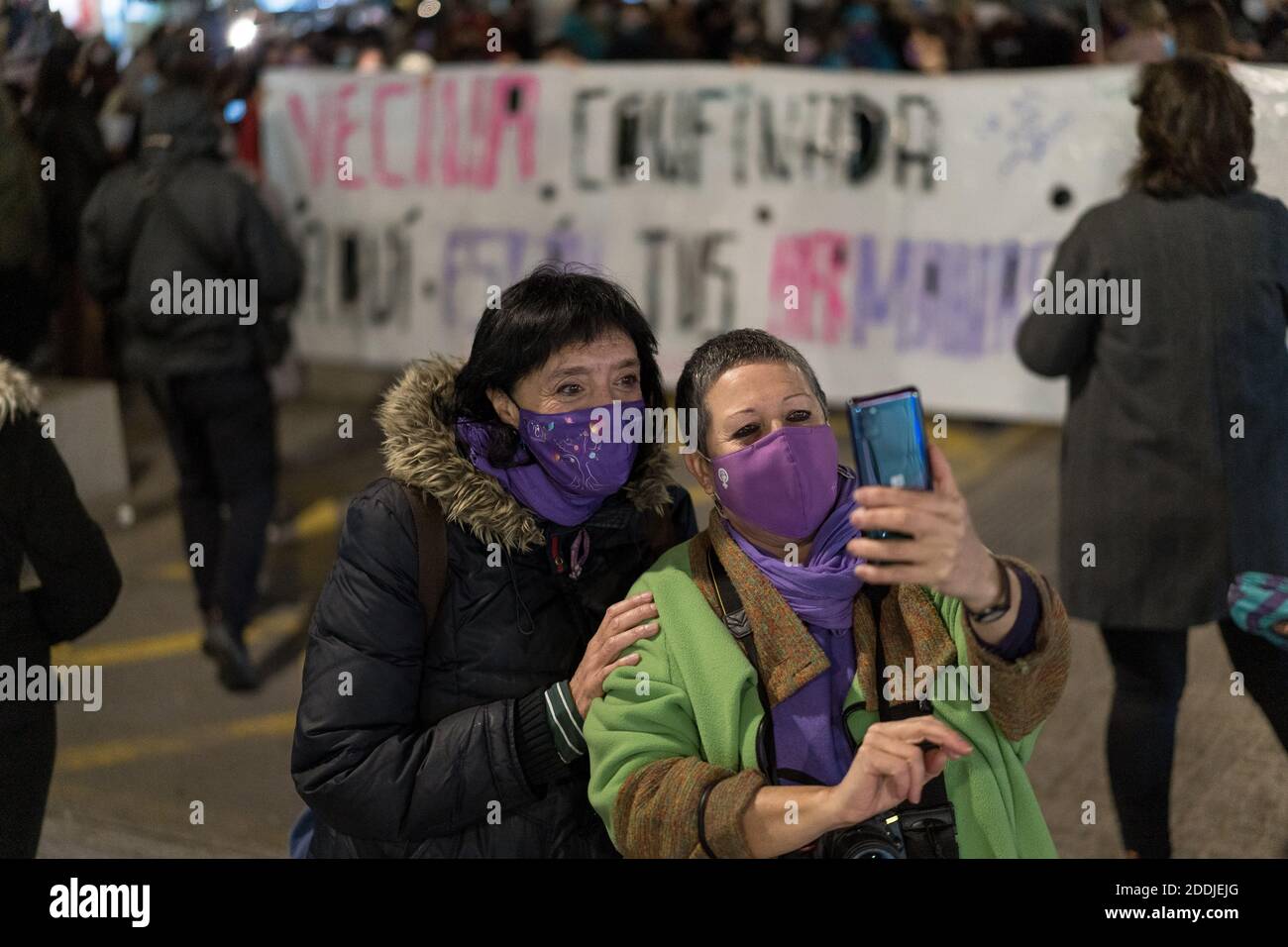 Female protesters wearing face masks take a selfie during a feminist ...