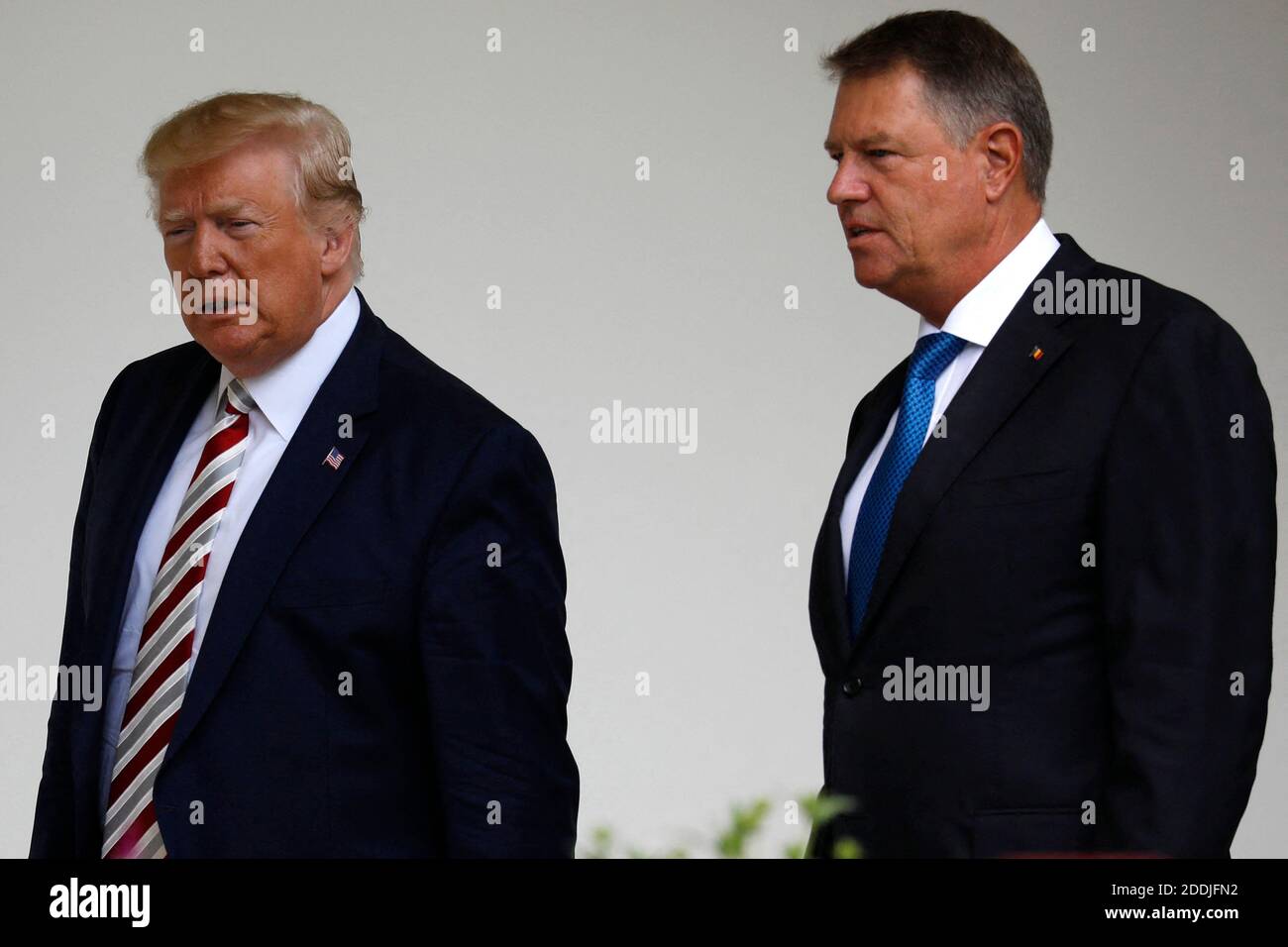 U.S. President Donald Trump walks with Romanian President Klaus ...