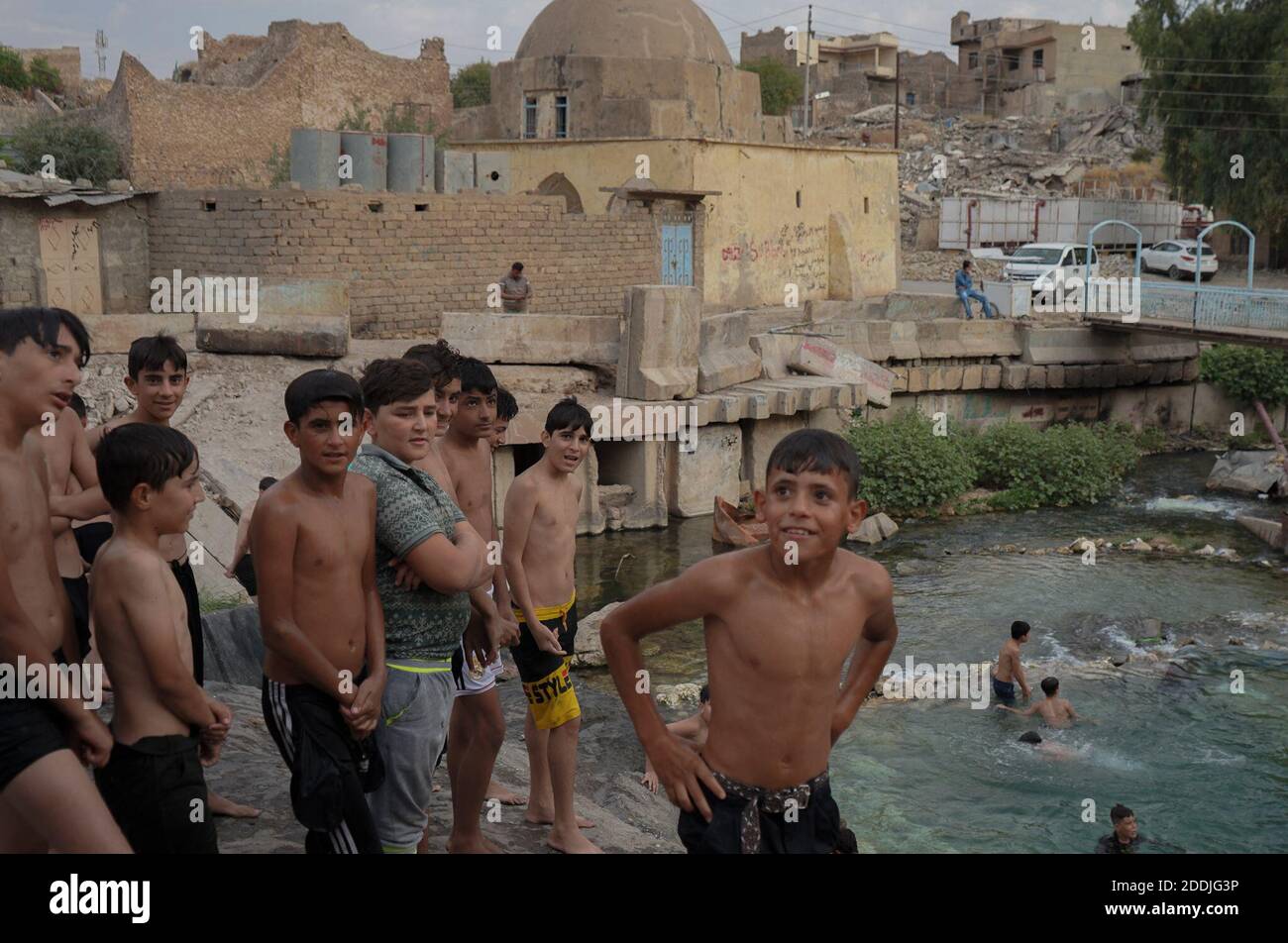EXCLUSIVE. Iraqi boys having fun, jumping and swimming in the river ...