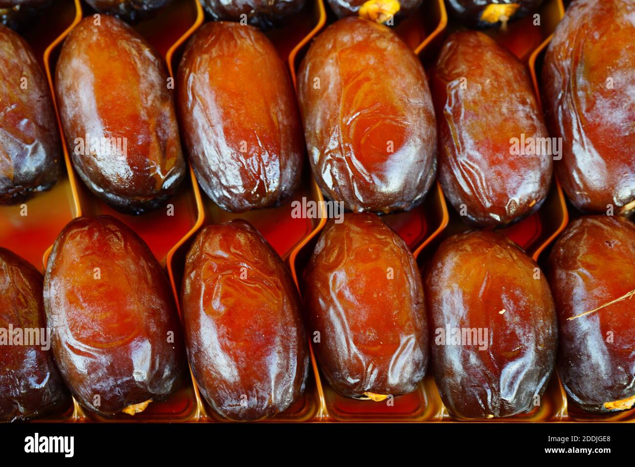 Dried sweet dates in bulk at a food market Stock Photo - Alamy
