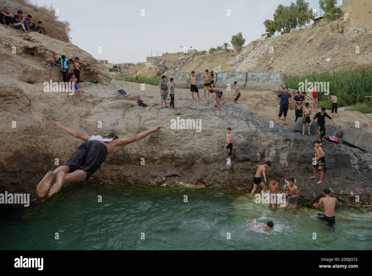 EXCLUSIVE. Iraqi boys having fun, jumping and swimming in the river ...