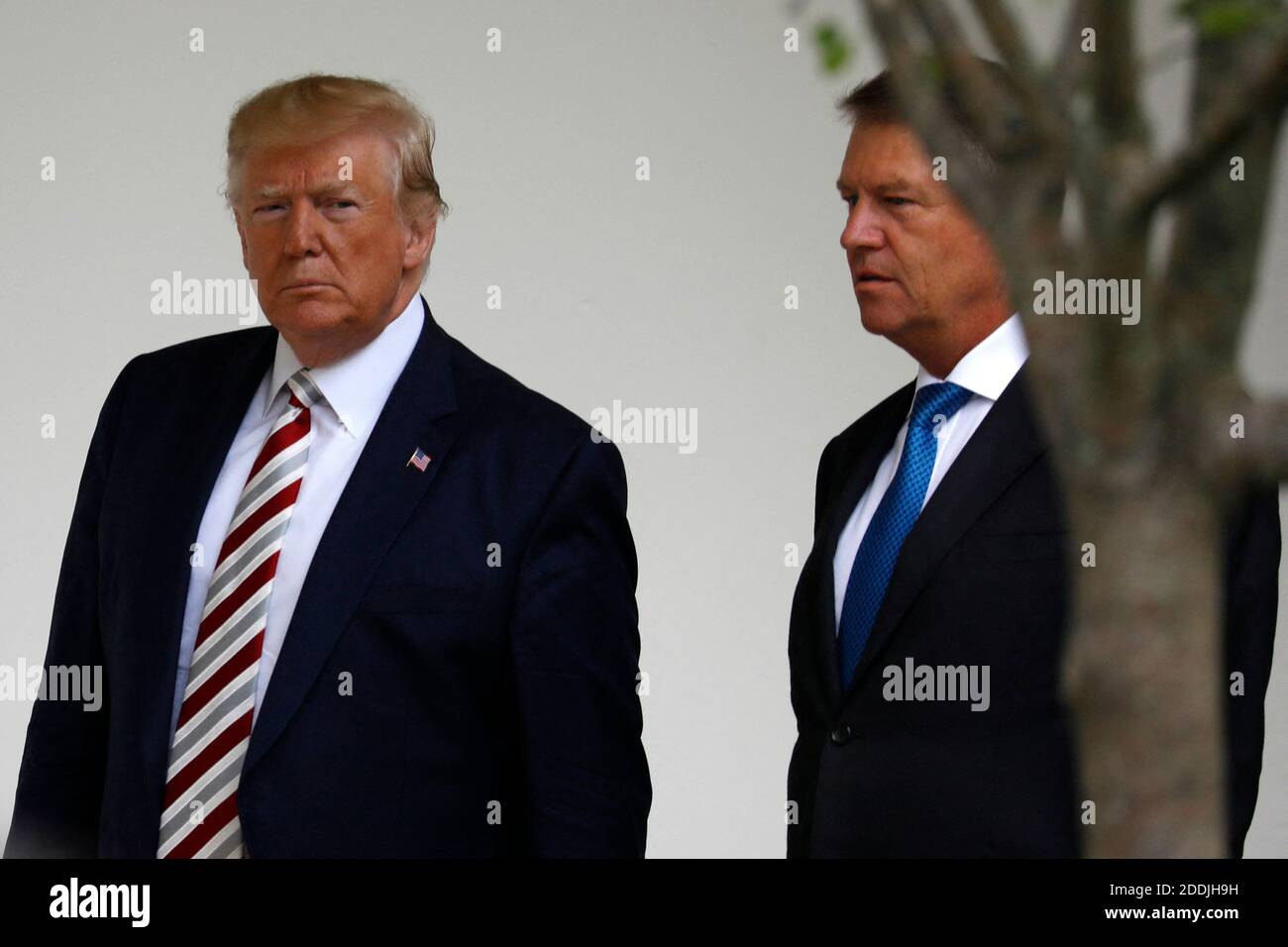 U.S. President Donald Trump walks with Romanian President Klaus ...