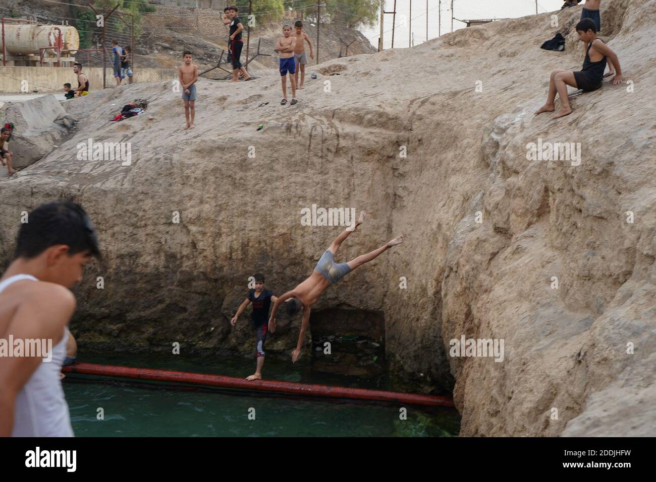 EXCLUSIVE. Iraqi boys having fun, jumping and swimming in the river ...