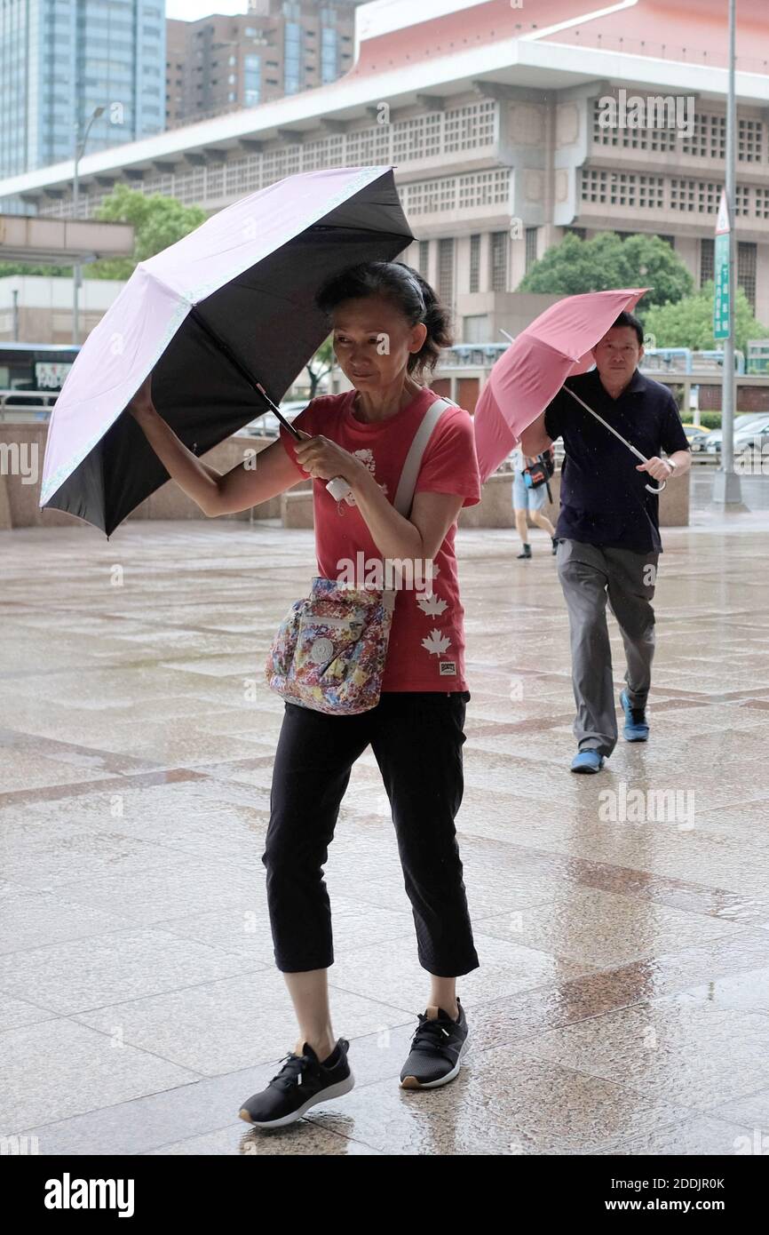 People struggle with heavy rain and strong winds brought by typhoon ...