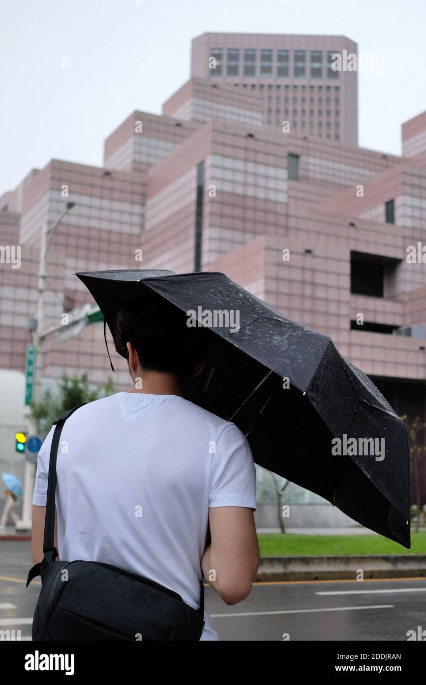 People struggle with heavy rain and strong winds brought by typhoon ...