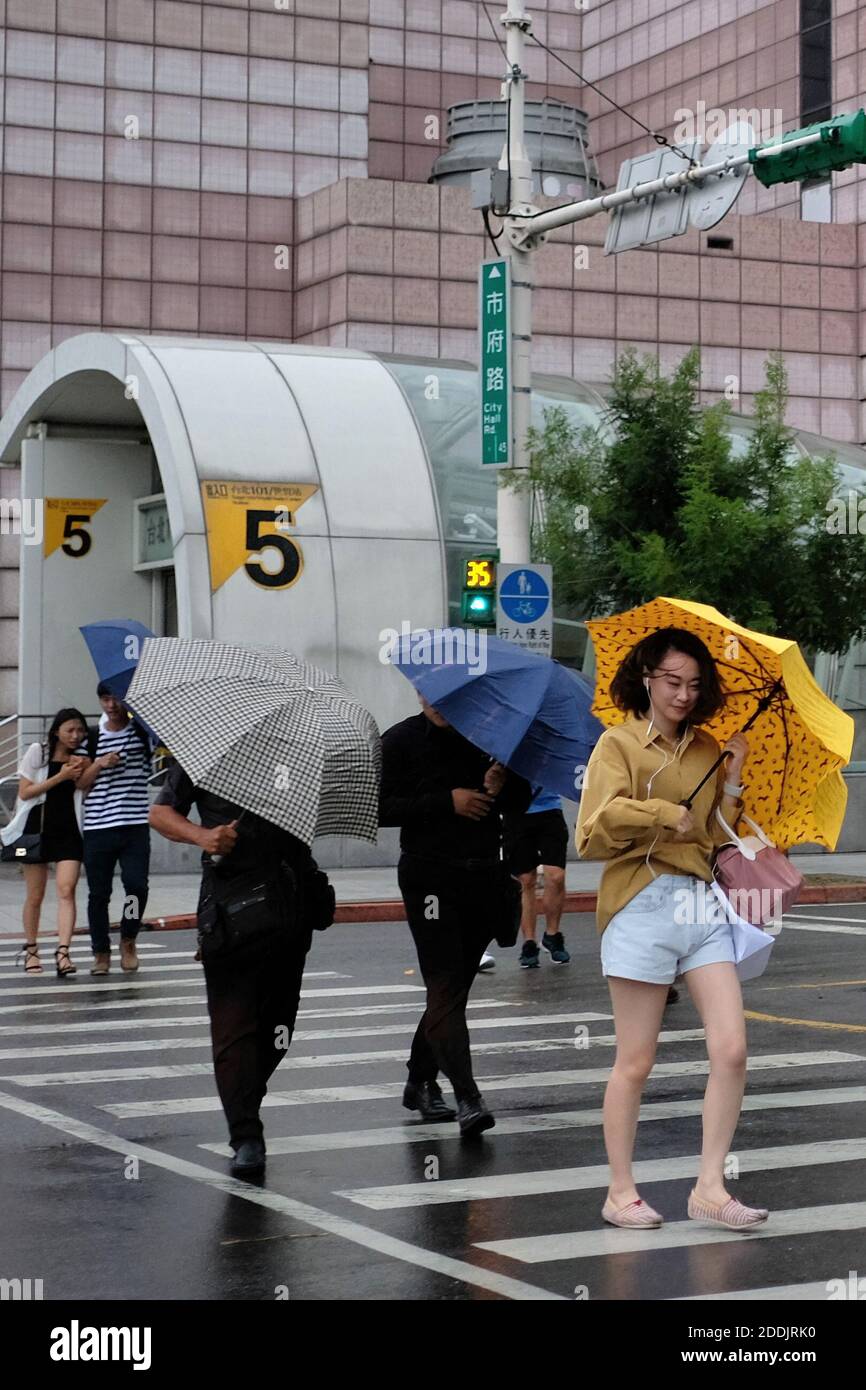 People struggle with heavy rain and strong winds brought by typhoon ...