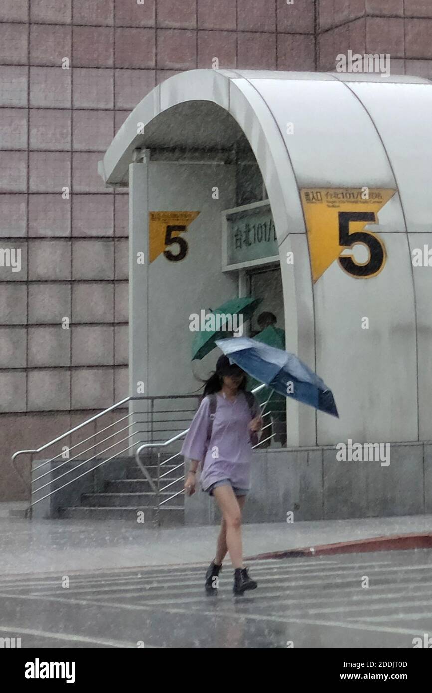 People struggle with heavy rain and strong winds brought by typhoon ...