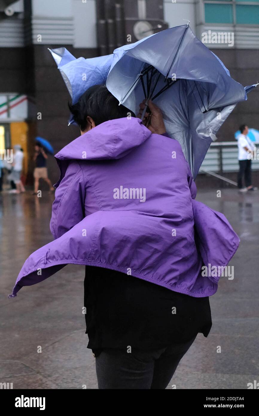 People struggle with heavy rain and strong winds brought by typhoon ...