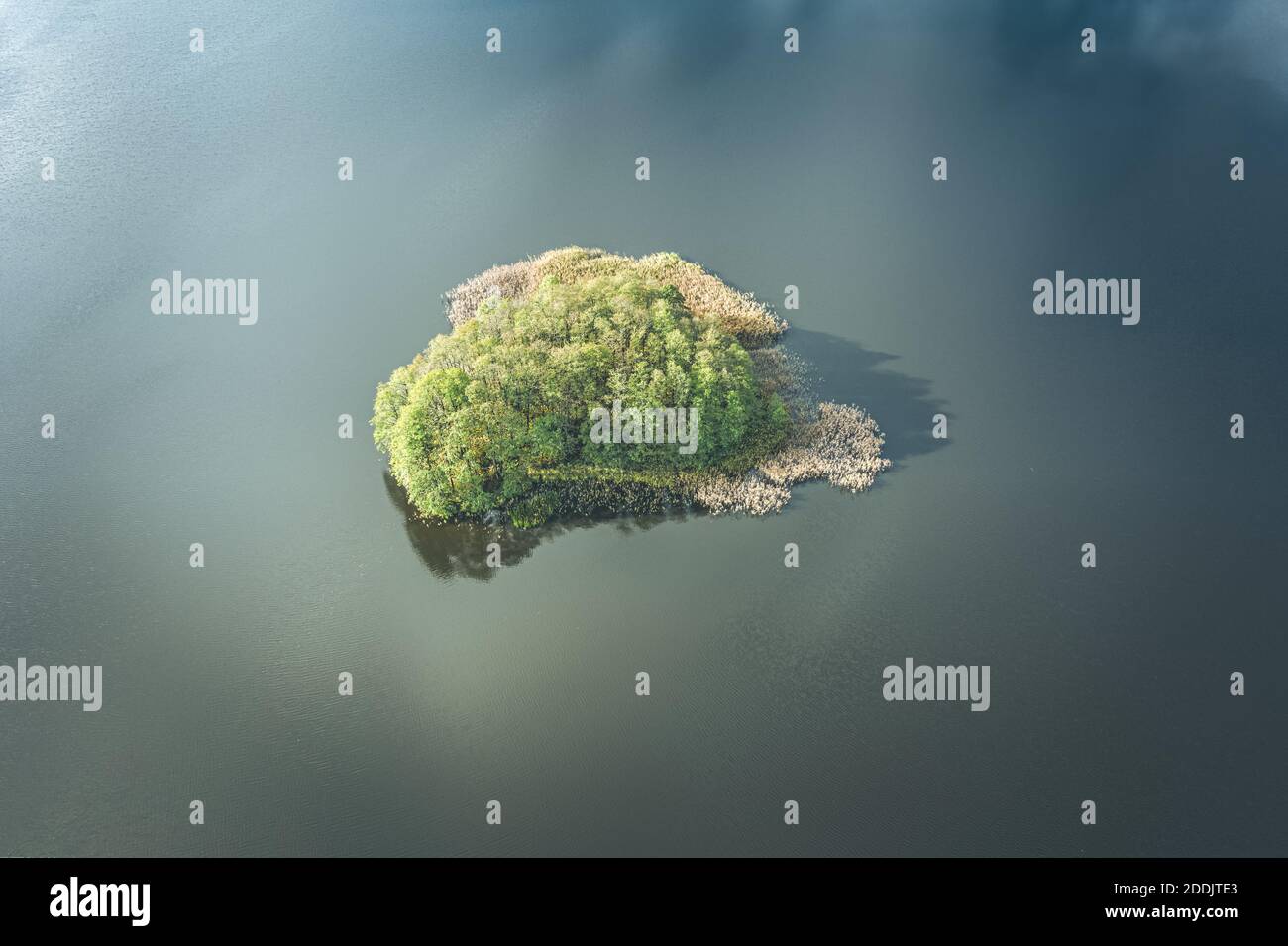 Aerial view of small island on the lake and clouds and sky reflecting ...