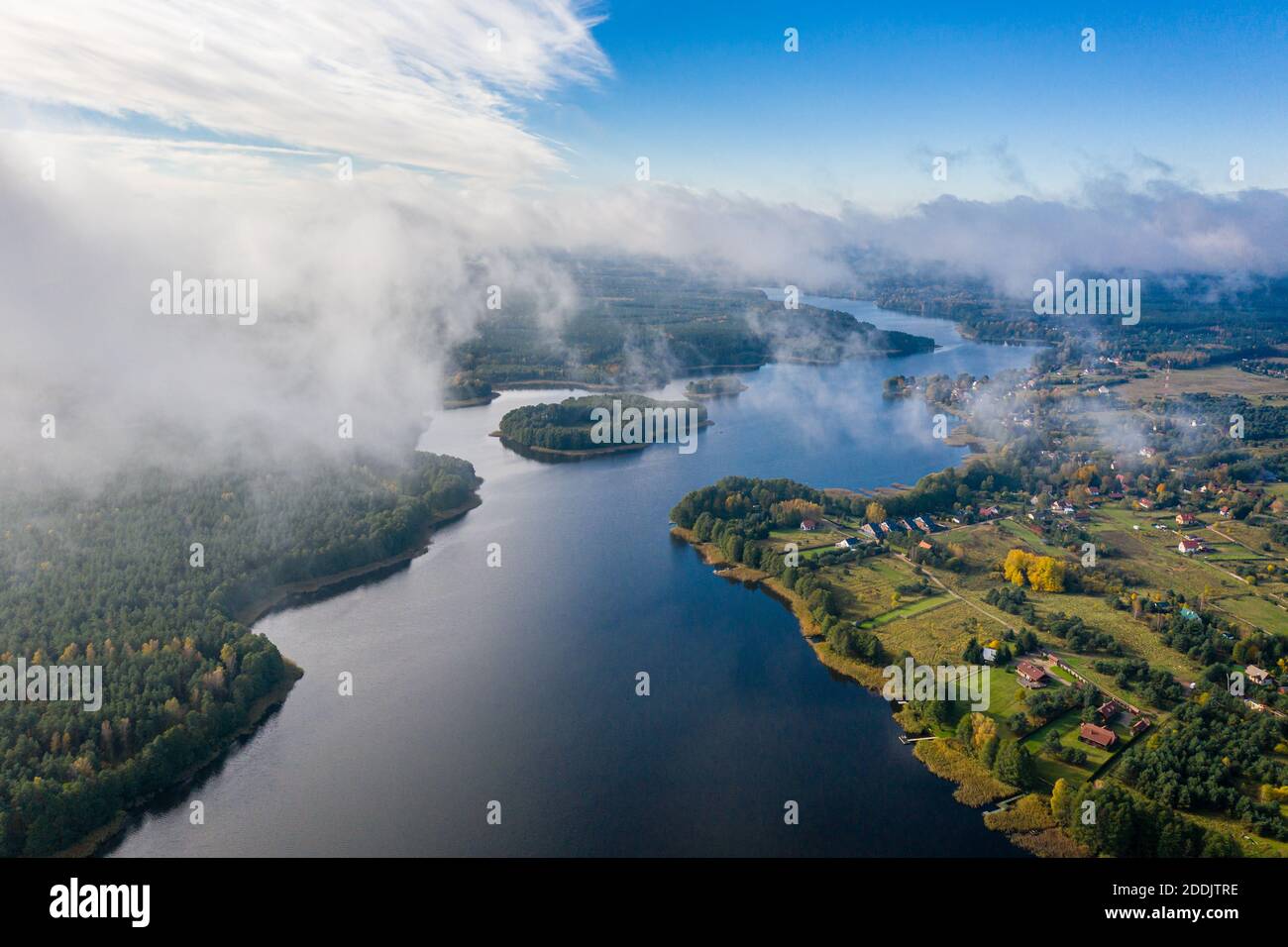 Aerial view of lake and clouds below Stock Photo - Alamy