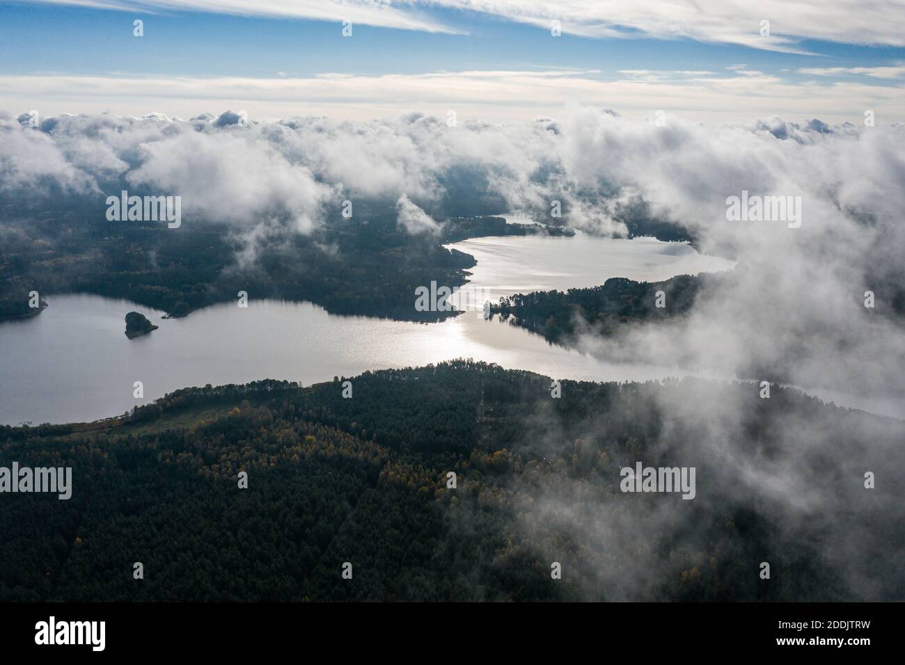 Aerial view of lake and clouds below Stock Photo - Alamy