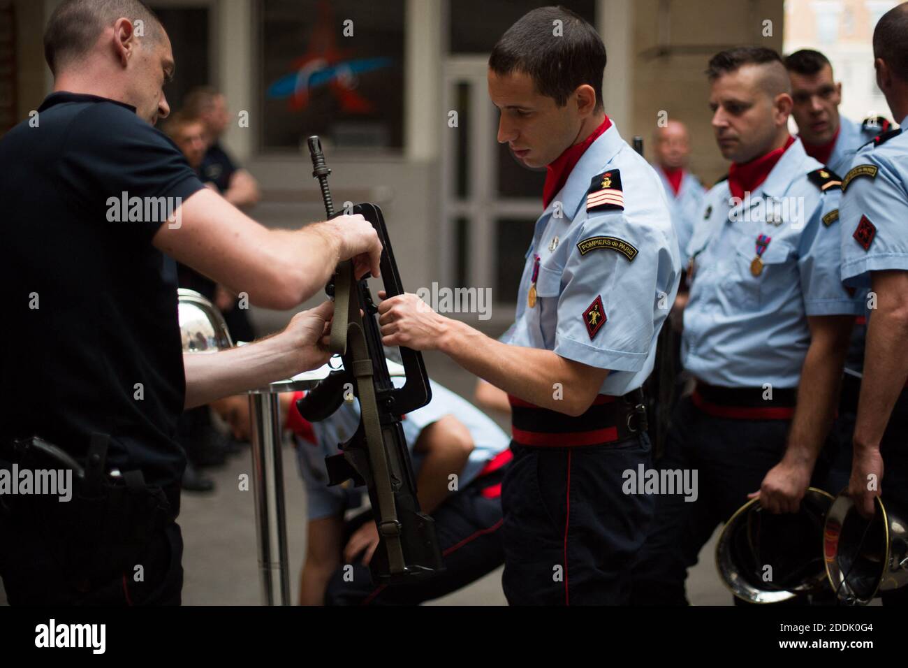 Firefighters in ceremonial uniform gives their weapon (FAMAS) back ...