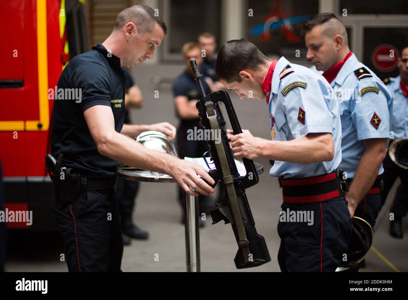 Firefighters in ceremonial uniform gives their weapon (FAMAS) back ...