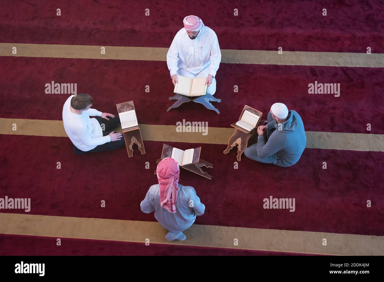 Group of muliethnic religious muslim young people praying and reading ...