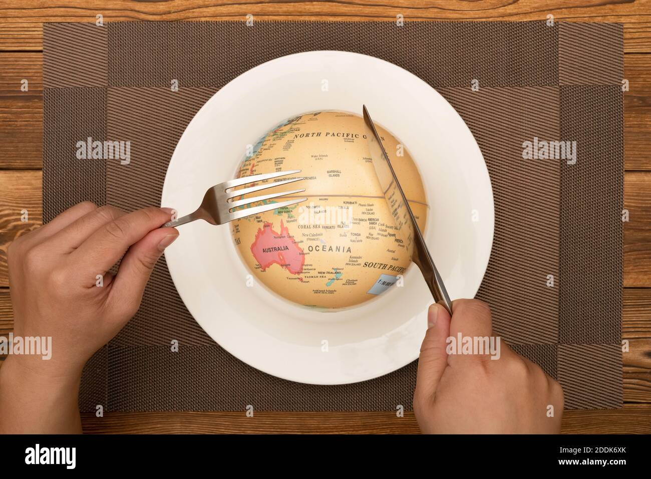 man eating a globe concept of overusing the resource of nature Stock ...