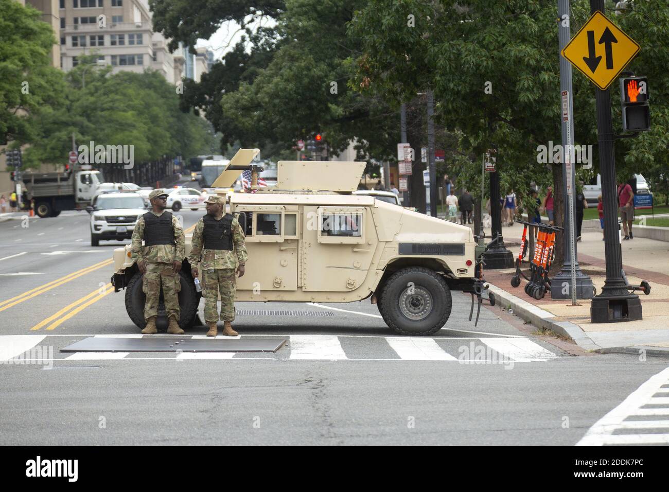 Military vehicles line the street prior to the Independence Day Parade ...