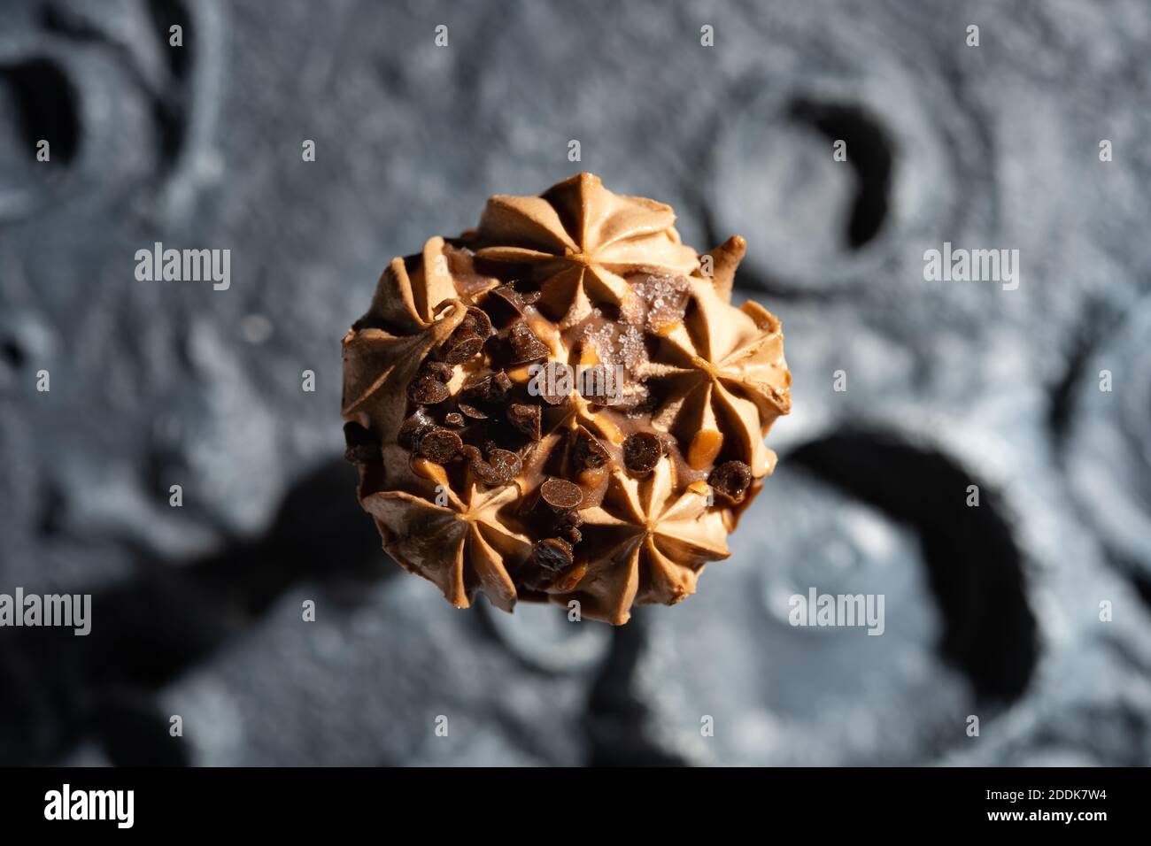 chocolate flavor ice cream on a rough surface with craters Stock Photo ...