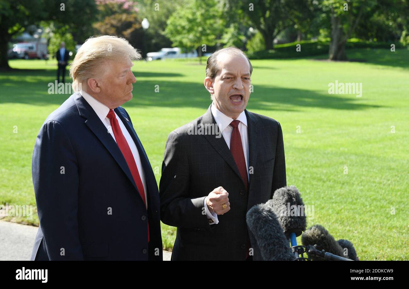 U.S. President Donald Trump stands with Labor Secretary Alex Acosta ...