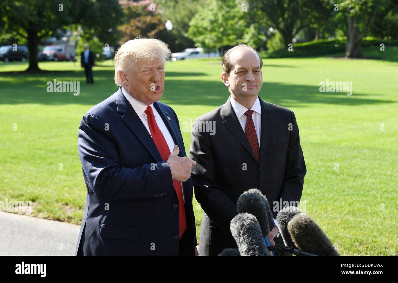 U.S. President Donald Trump stands with Labor Secretary Alex Acosta ...
