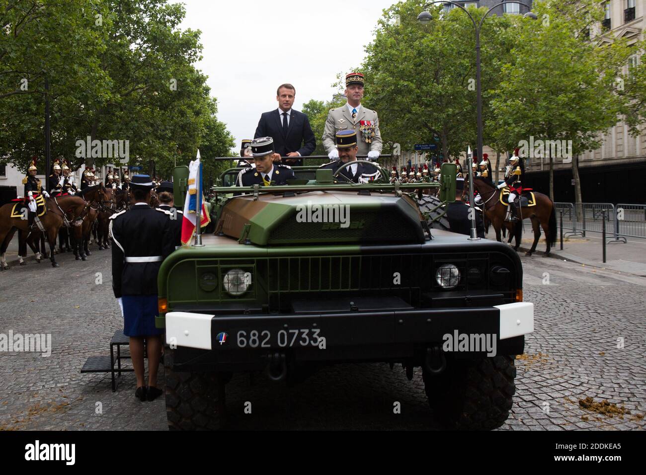 France's President Emmanuel Macron (L) stands in an Acmat VLRA vehicle ...