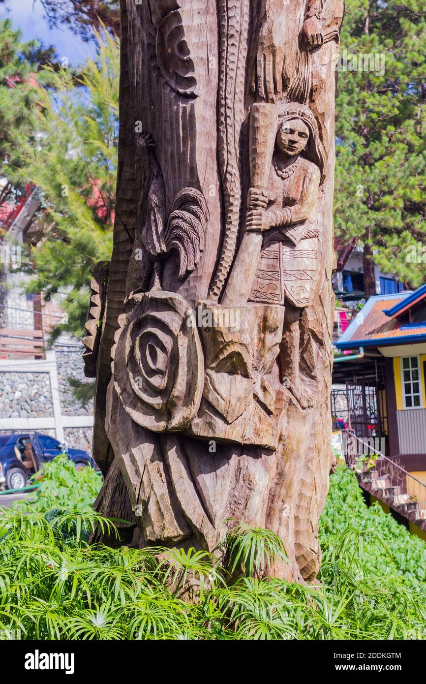 Detail of carving of a dead tree along a road in Baguio City ...