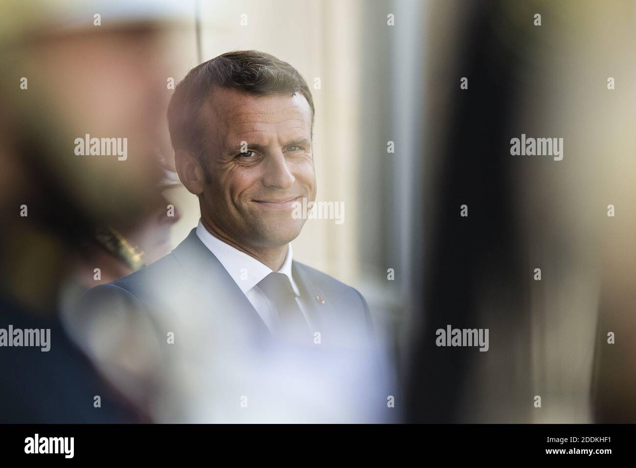 French President Emmanuel Macron gestures and smiles at the Elysee ...