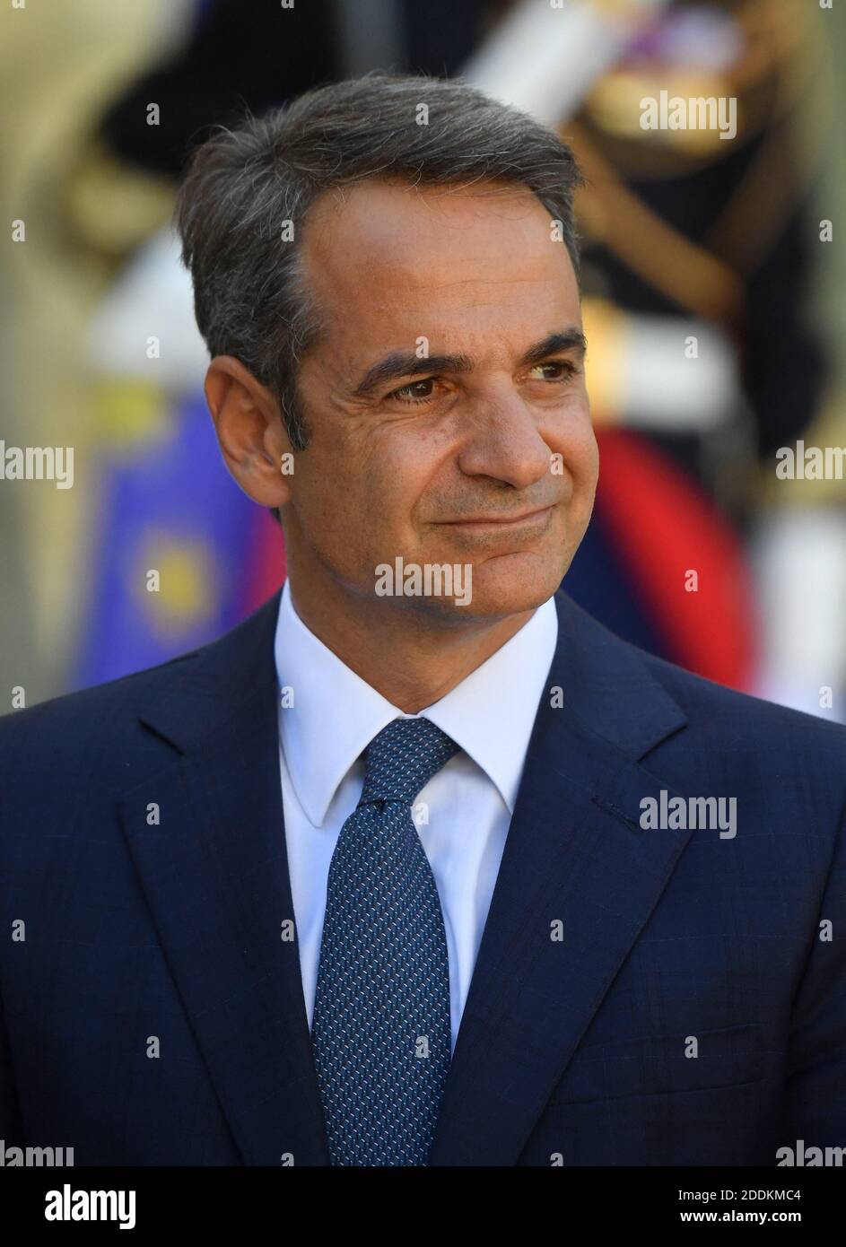 Greek Prime Minister Kyriakos Mitsotakis looks on as he arrives prior ...