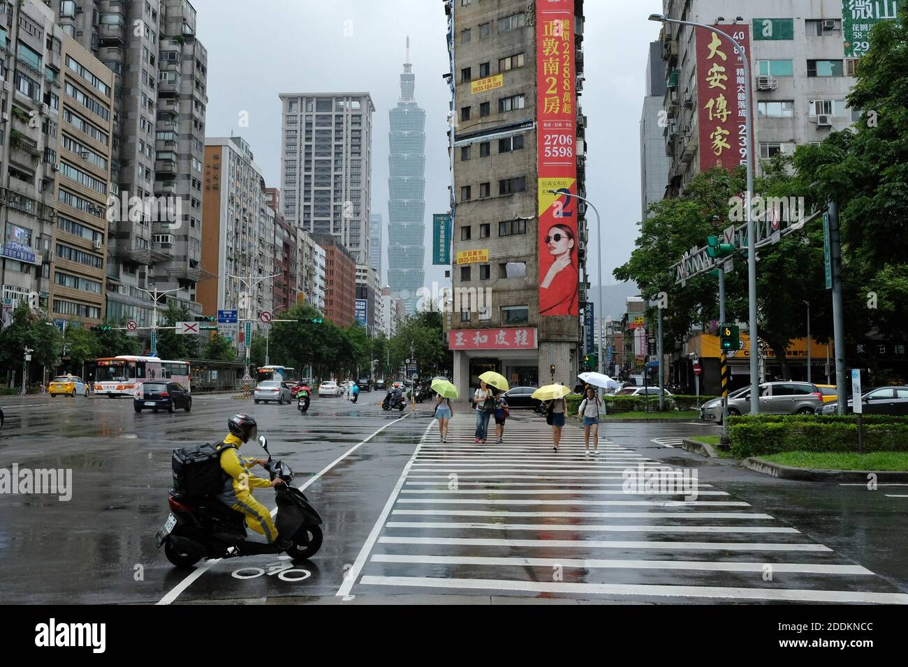 People struggle with heavy winds and rain while crossing the street as ...