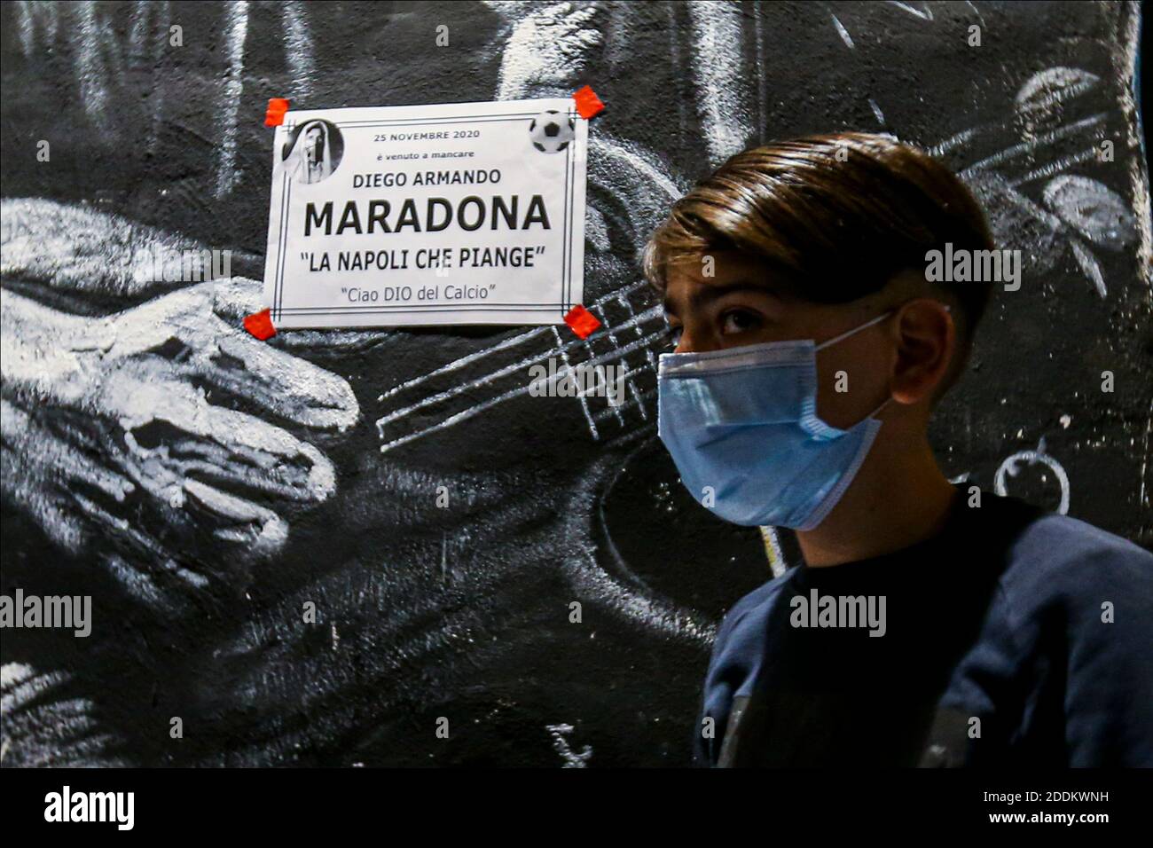 Naples, Italy. 25th Nov, 2020. a child wearing a mask in front of the ...