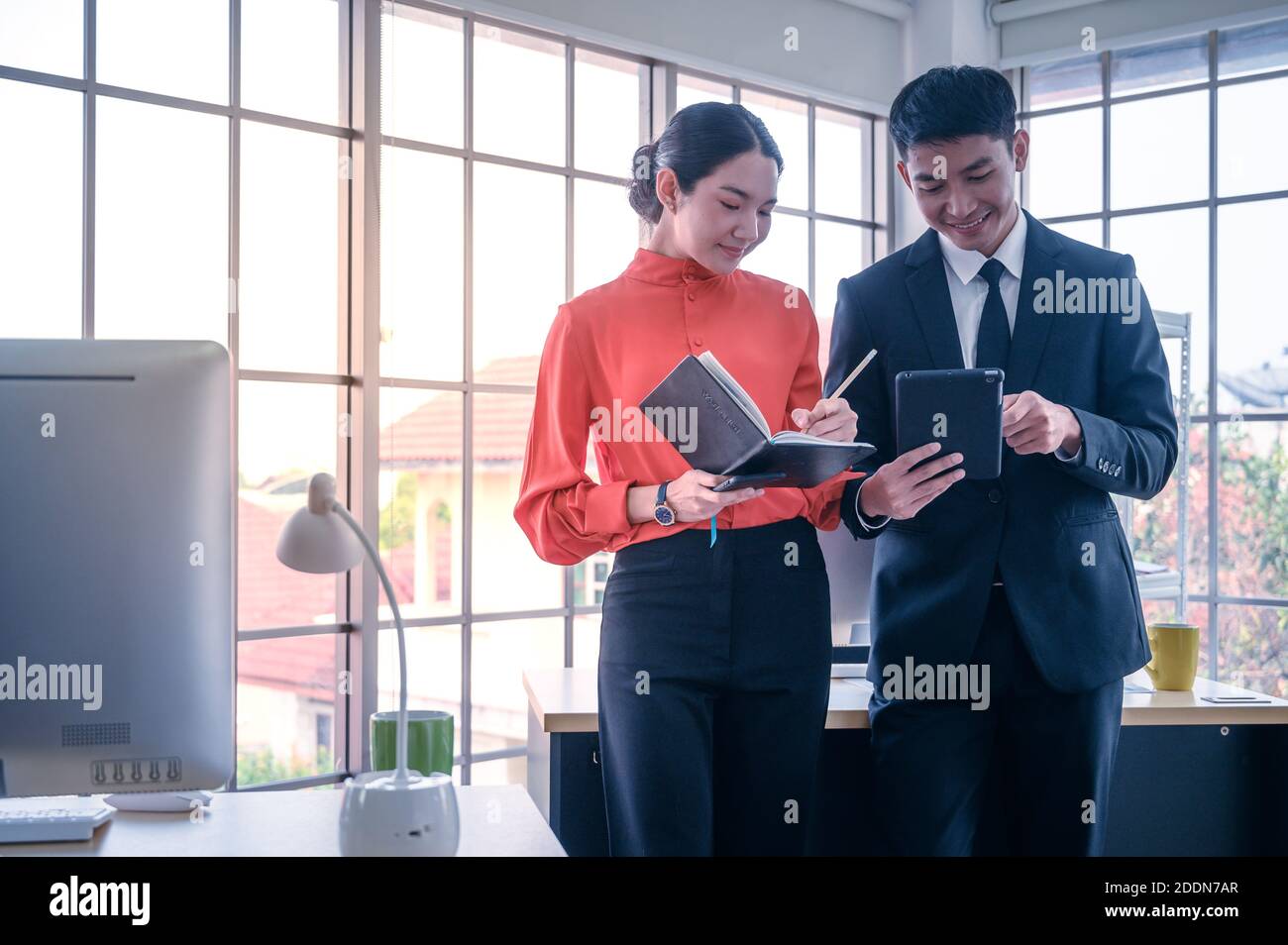 Businessman and businesswoman teamwork talking at office workplace ...